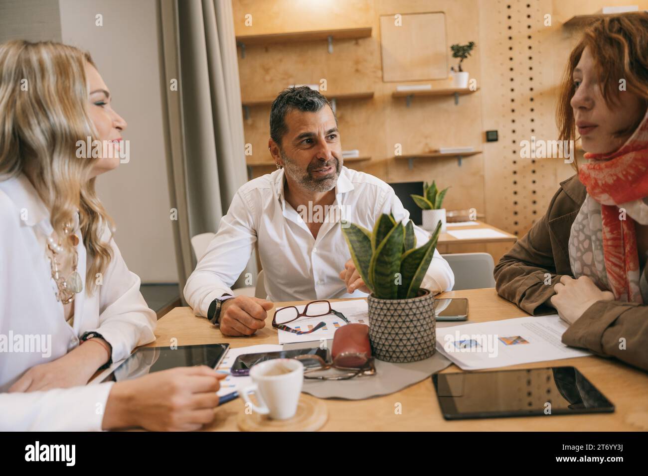Worried ginger muslim business girl explaining her mistake to her ...