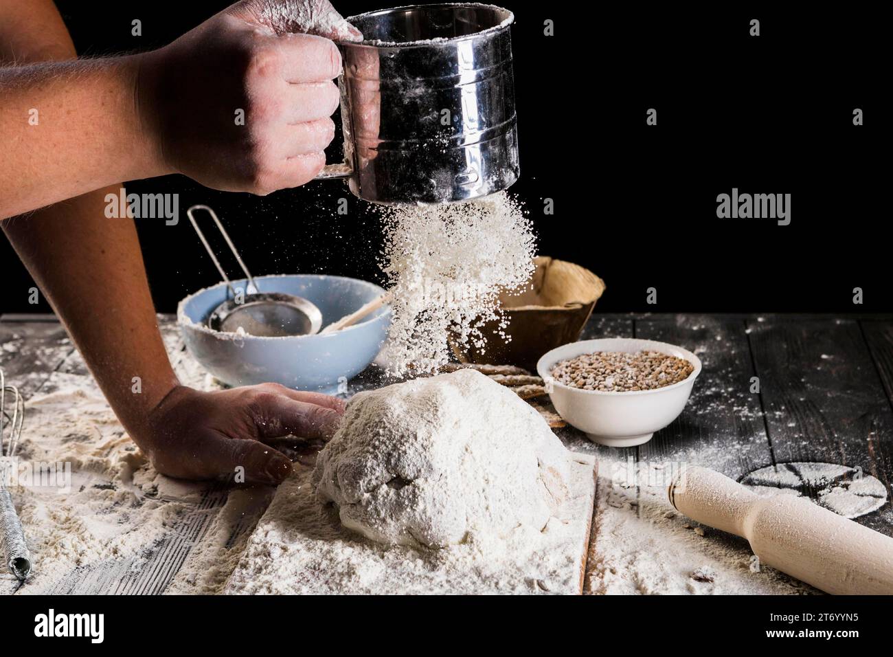 Baker sifts flour through sieve hi-res stock photography and images - Alamy