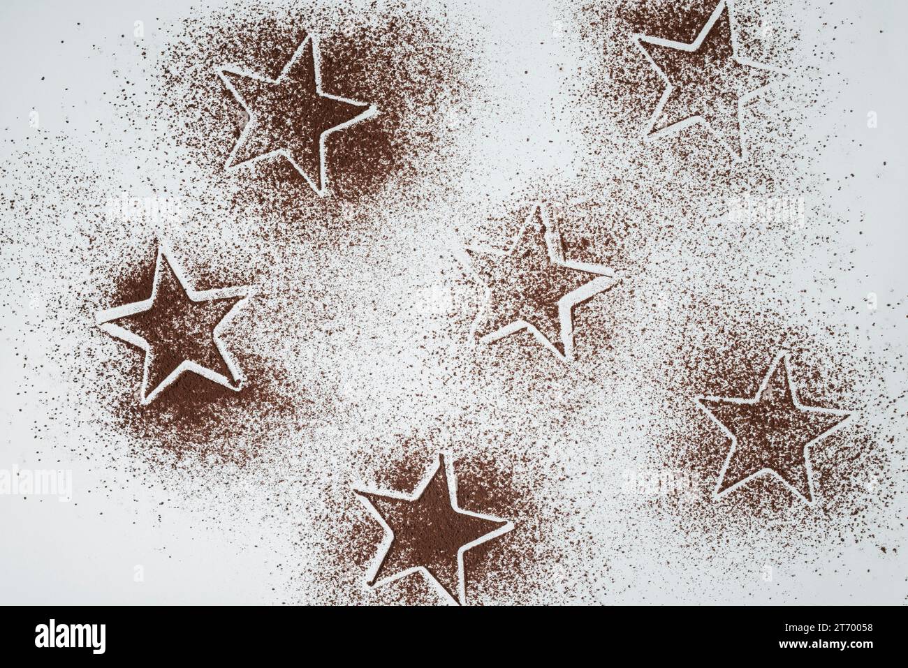 Cocoa powder star shapes white background Stock Photo - Alamy