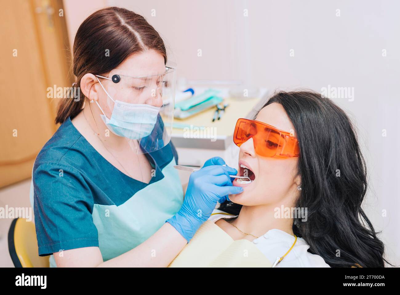 Dentist examining teeth patient glasses Stock Photo - Alamy