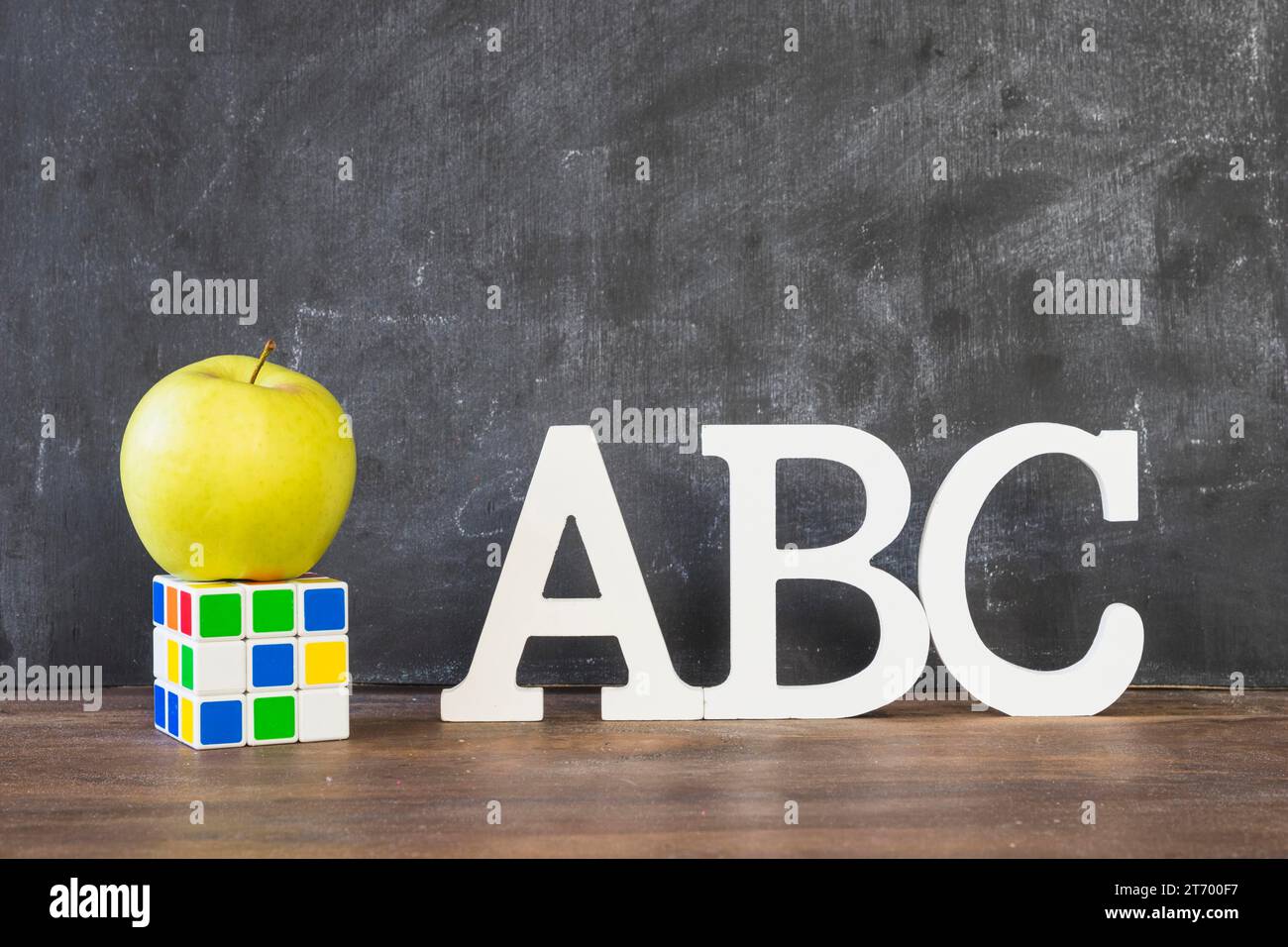 Desk with alphabet characters rubiks cube apple Stock Photo - Alamy