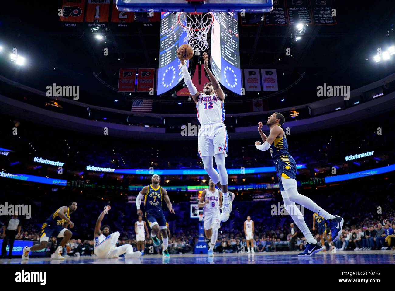 Philadelphia 76ers' Tobias Harris, center, goes up for a shot past ...