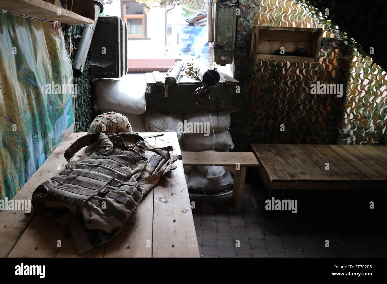 A military helmet of a Ukrainian soldier with a heavy bulletproof vest ...
