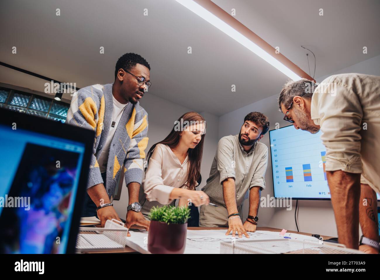 Multiracial Team of Architects and Engineers Collaborating on Project ...