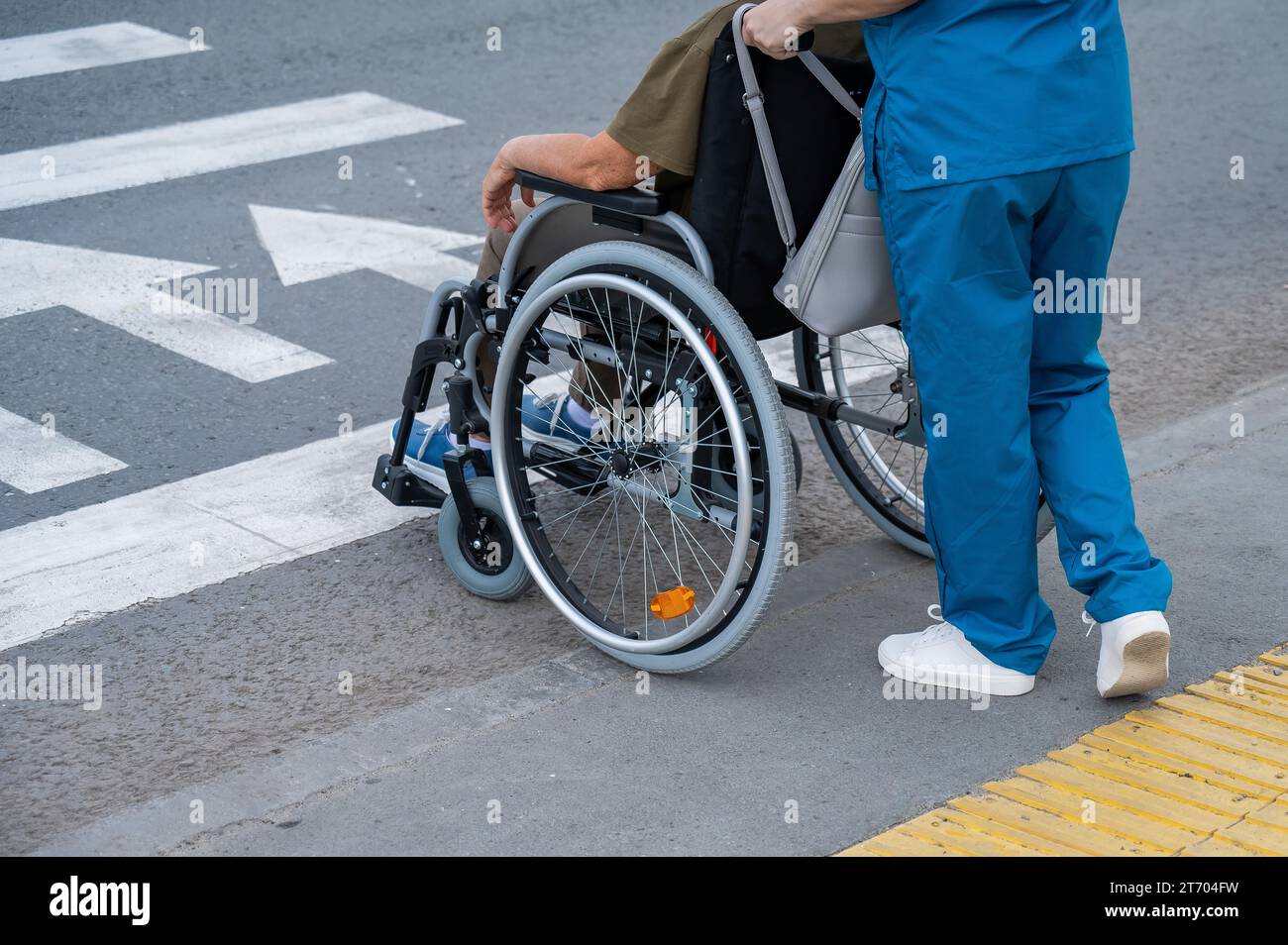 Helping elderly cross street hi-res stock photography and images - Alamy