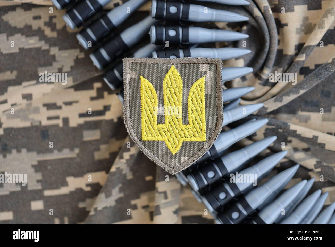 Ukrainian army symbol on machine gun belt lies on ukrainian pixeled ...