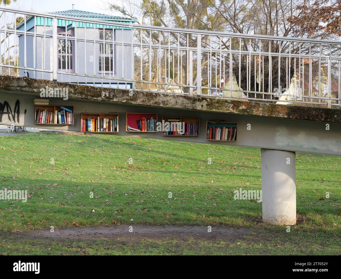 Bookshelves hanging under a bridge as a public library for swapping ...