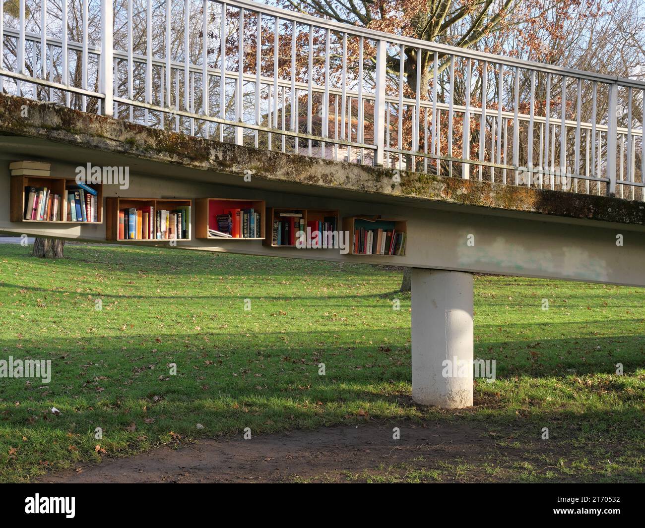 Bookshelves hanging under a bridge as a public library for swapping ...
