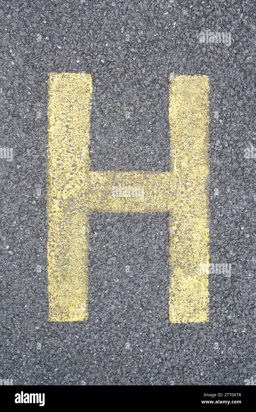 the Letter H are drawn with color paint on asphalt. a children's ...