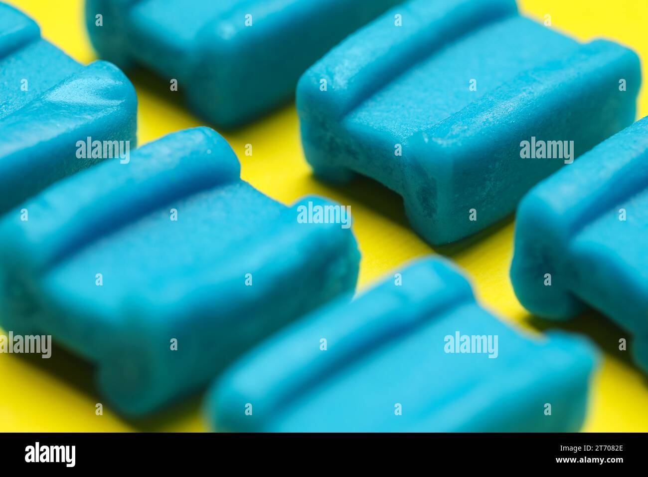 Blue bubble gums on yellow background, closeup Stock Photo - Alamy