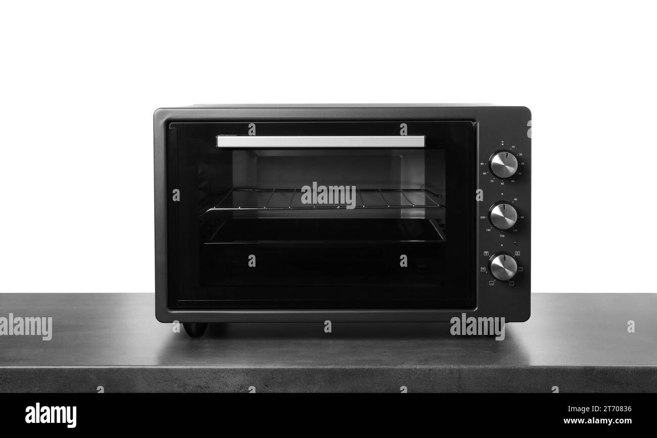 One electric oven on grey table against white background Stock Photo ...