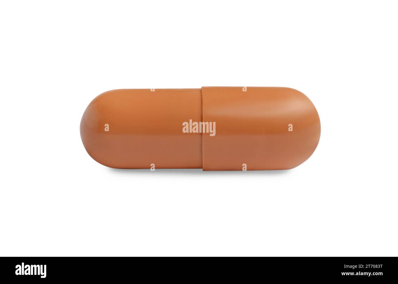 One brown pill on white background. Medicinal treatment Stock Photo - Alamy