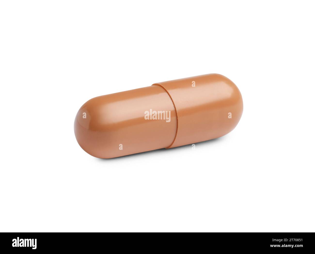 One brown pill on white background. Medicinal treatment Stock Photo - Alamy