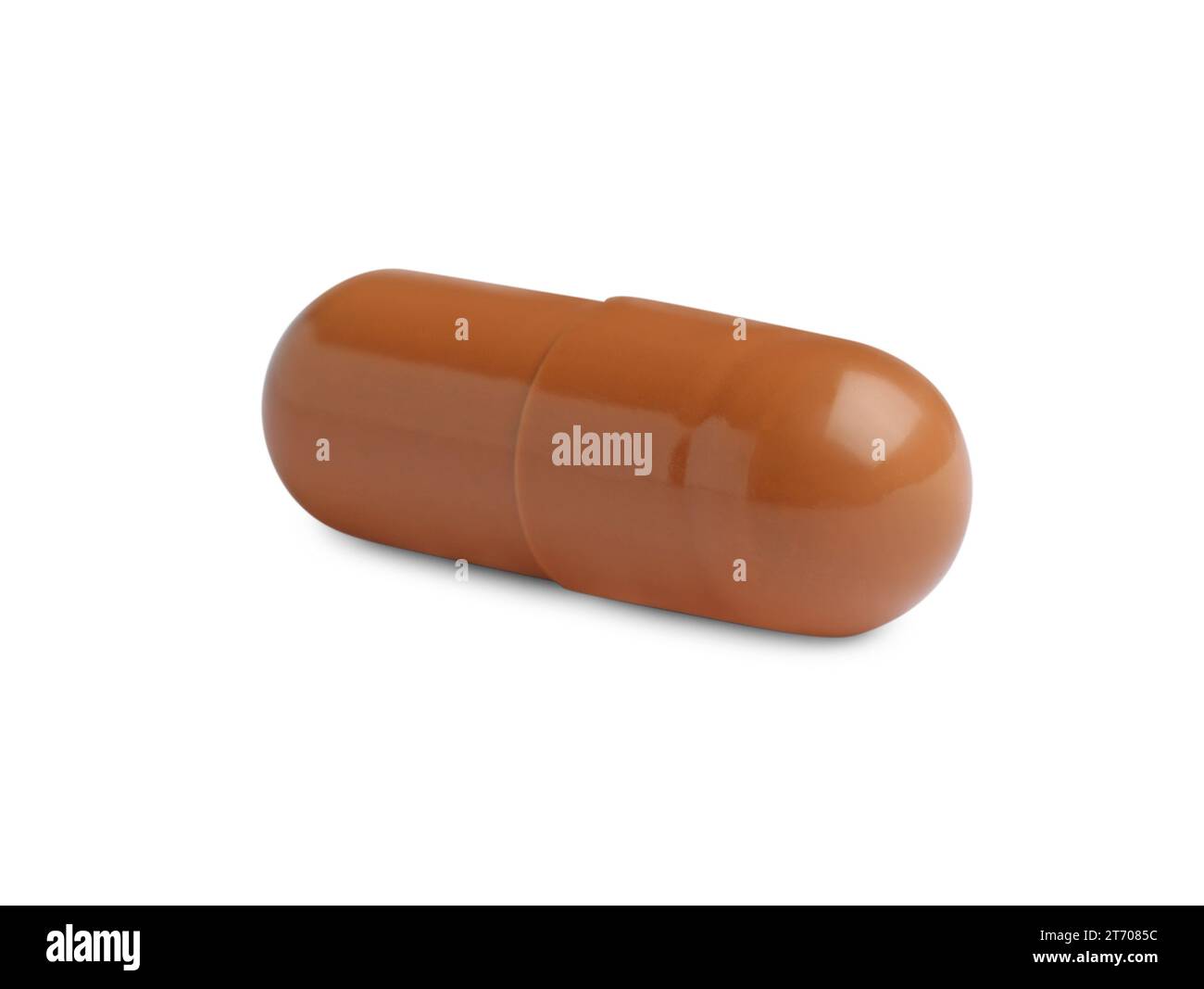 One brown pill on white background. Medicinal treatment Stock Photo - Alamy