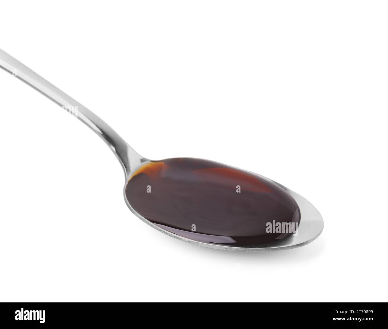 Spoon with delicious caramel syrup isolated on white Stock Photo - Alamy