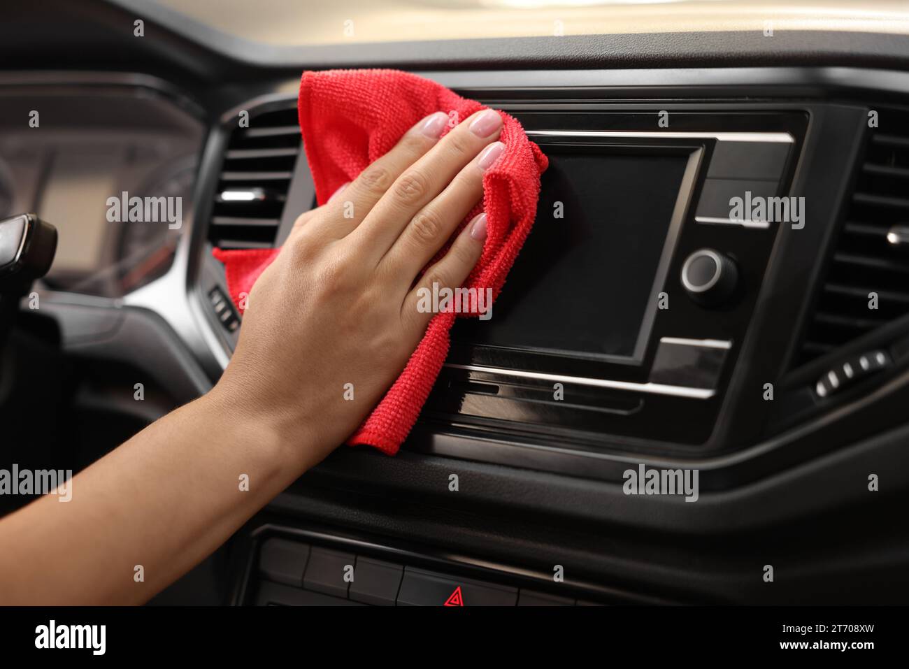 Woman cleaning center console with rag in car, closeup Stock Photo - Alamy