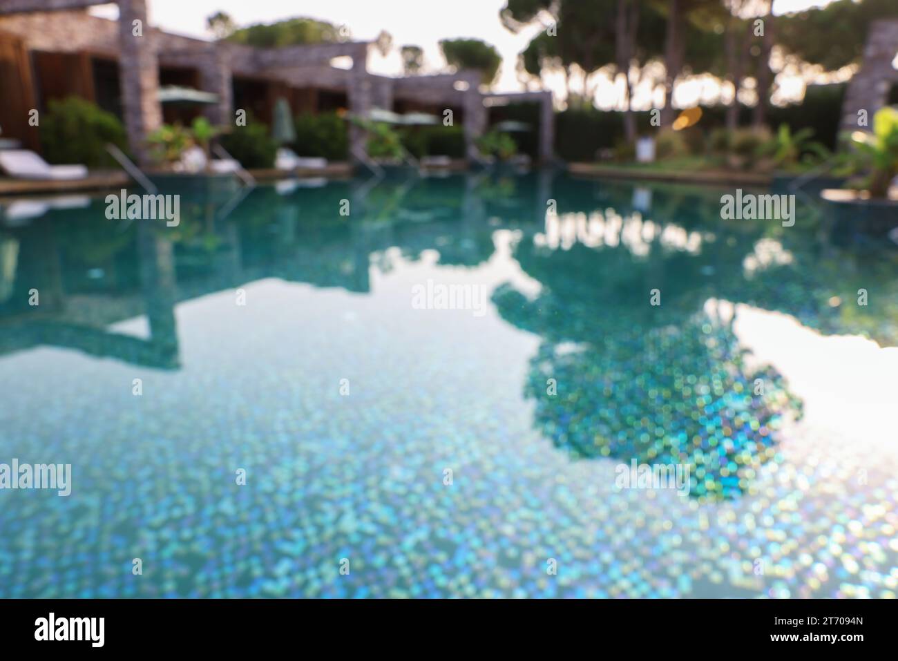 Outdoor swimming pool at resort, blurred view Stock Photo - Alamy