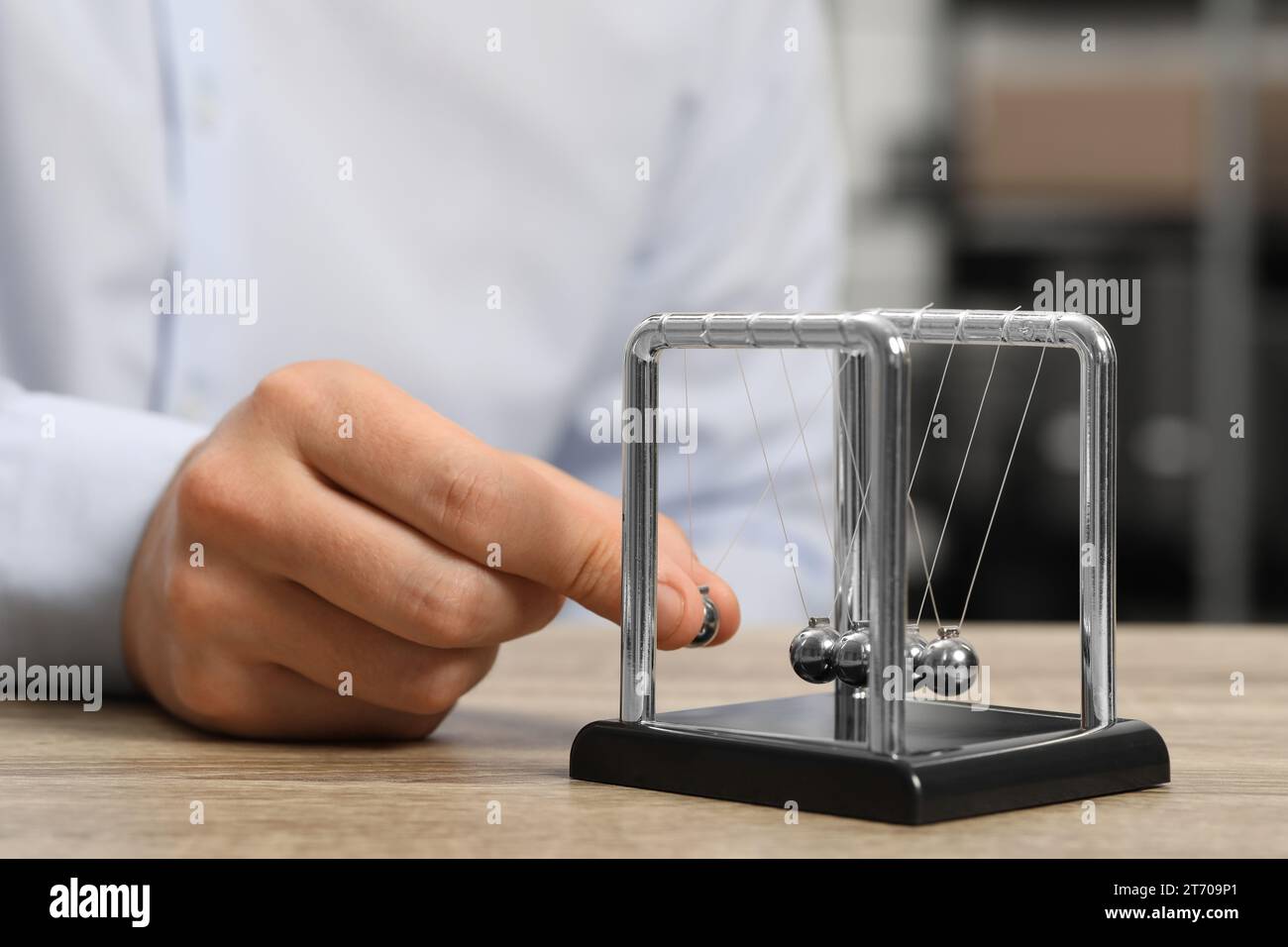 Newton's cradle and hand hi-res stock photography and images - Alamy