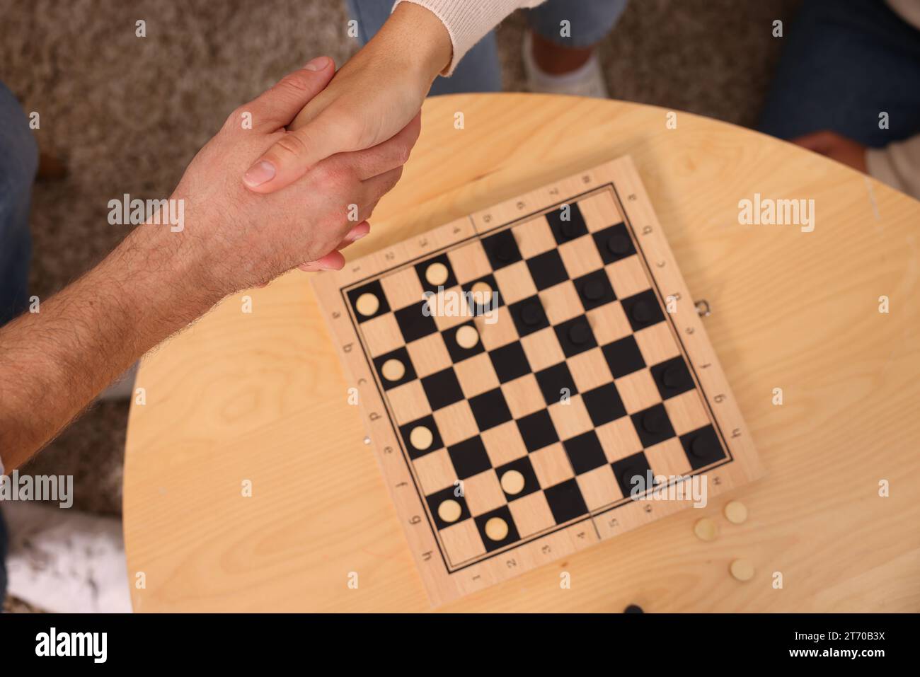 Checkers. Players shaking hands after game indoors, top view Stock ...