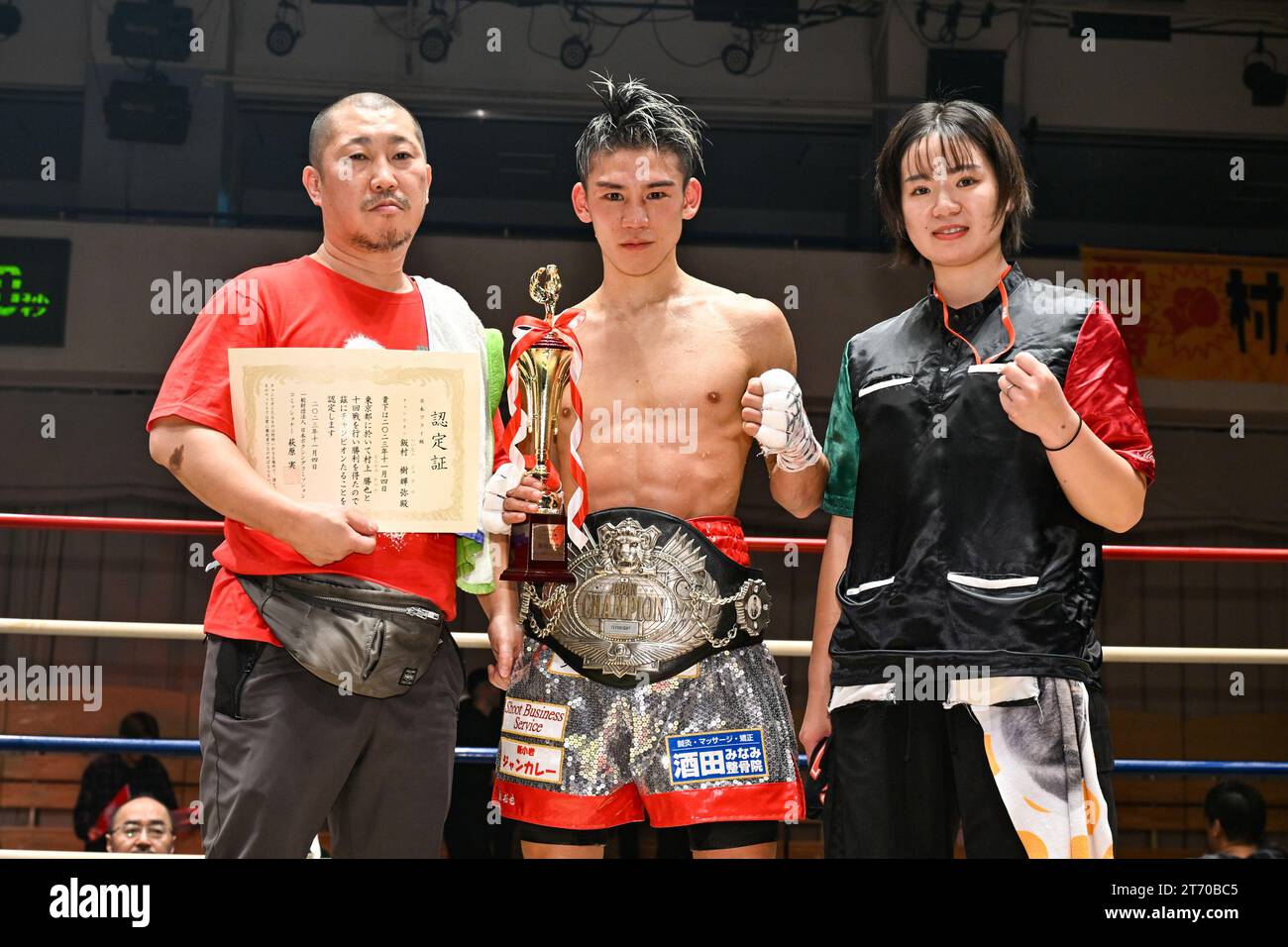 Champion Jukiya Iimura celebrates wih his trainer Naoki Sato (R) and ...