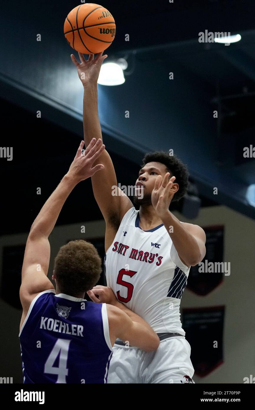 Saint Mary's forward Joshua Jefferson, right, shoots over Weber State ...