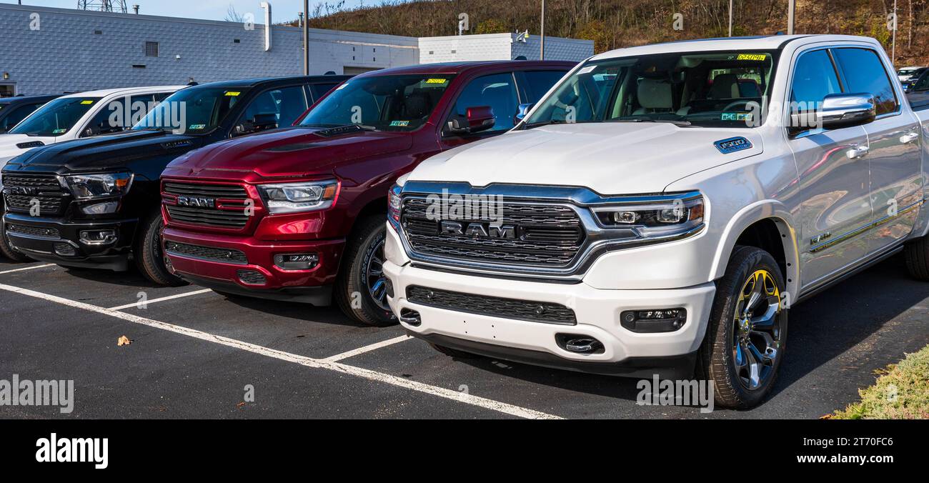 Three new Dodge Ram pickup trucks lined up for sale at a dealership in ...