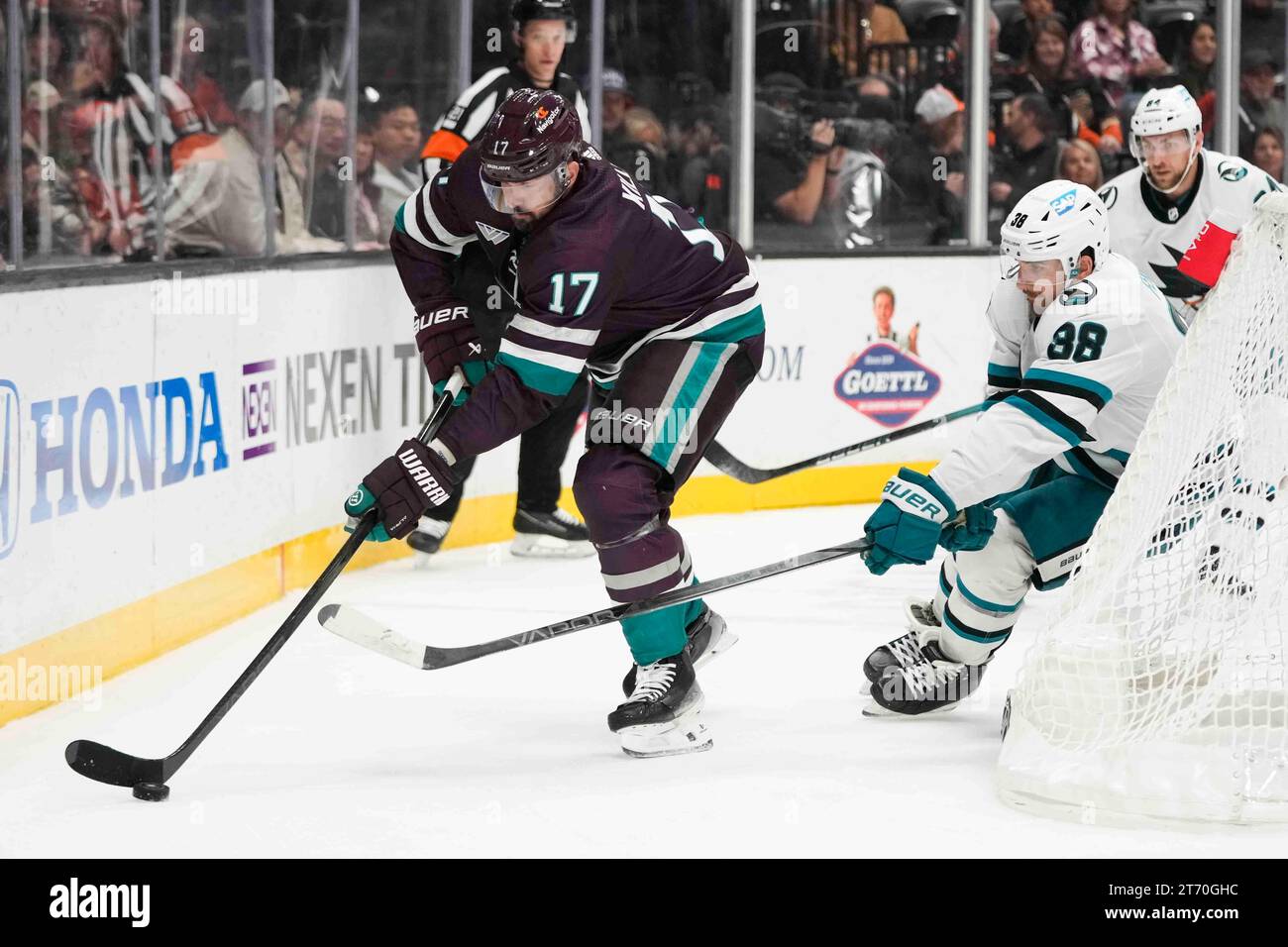 Anaheim Ducks' Alex Killorn (17) moves the puck under defense by San ...