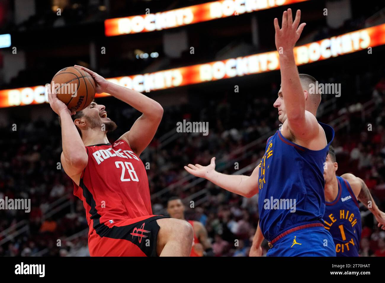 Houston Rockets' Alperen Sengun (28) shoots as Denver Nuggets' Nikola ...