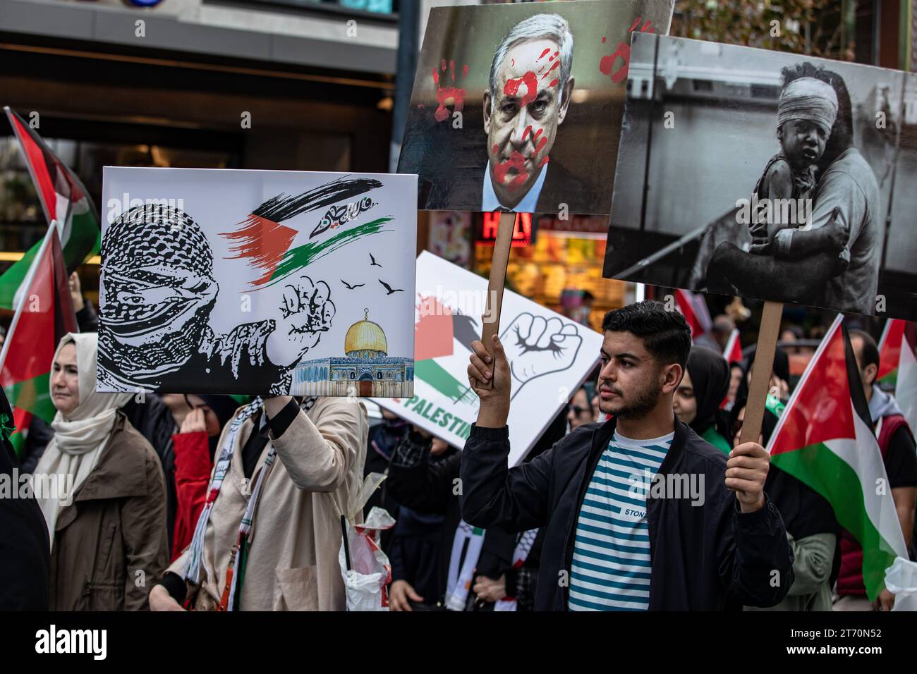 A pro-Palestinian demonstrator was seen carrying a banner with a photo ...