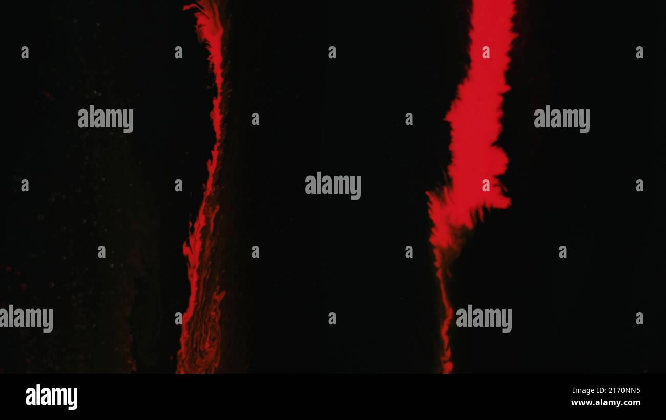 Paint drip ink pouring red dye spill flow on black Stock Photo - Alamy