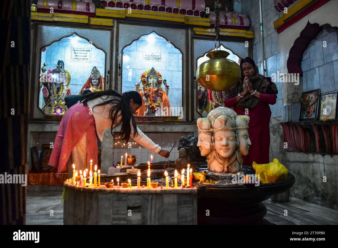 Hindu devotes perform rituals inside the temple on the occasion of ...