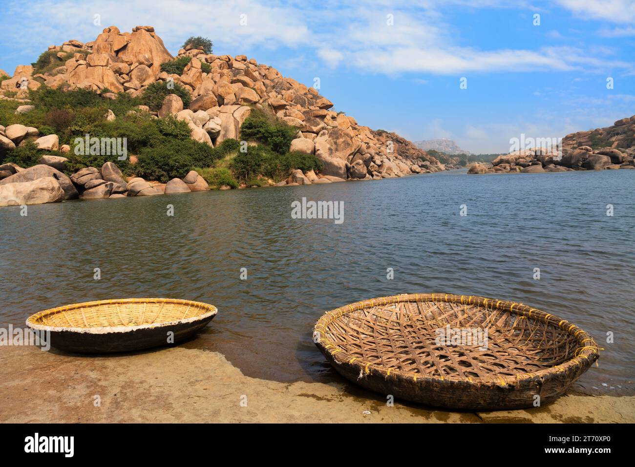 Coracle boats on the banks of the Tungabhadra river with hilly ...