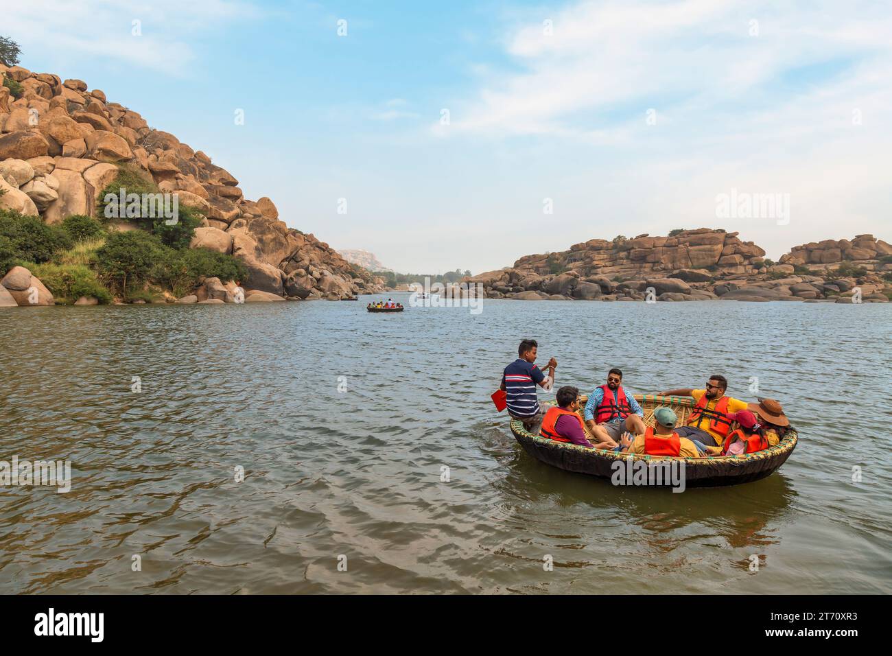 Tourist enjoy coracle boat ride on Tungabhadra river at Hampi Karnataka ...