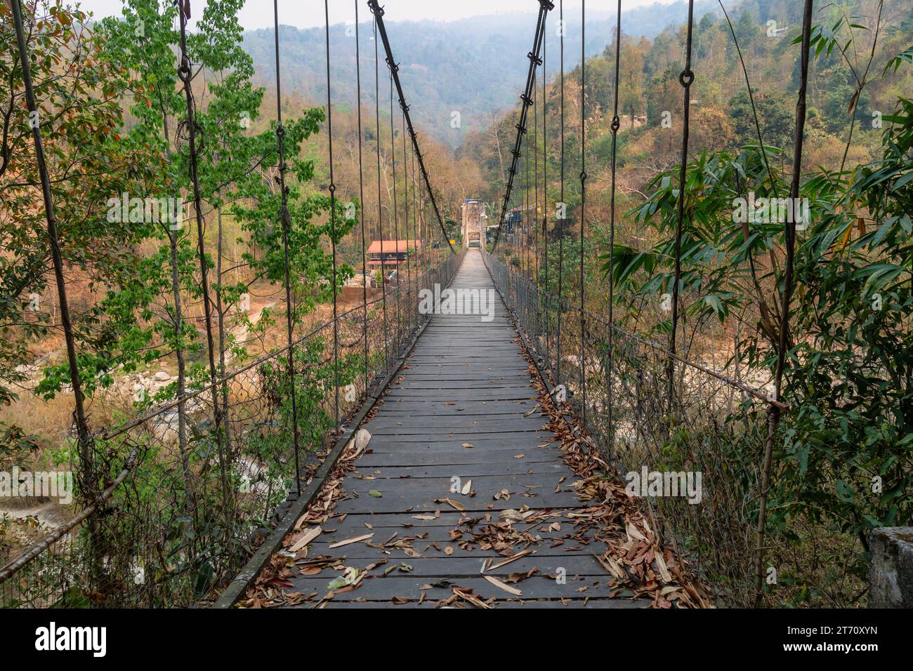 Hanging wooden bridge on Railey river surrounded by mountains at ...