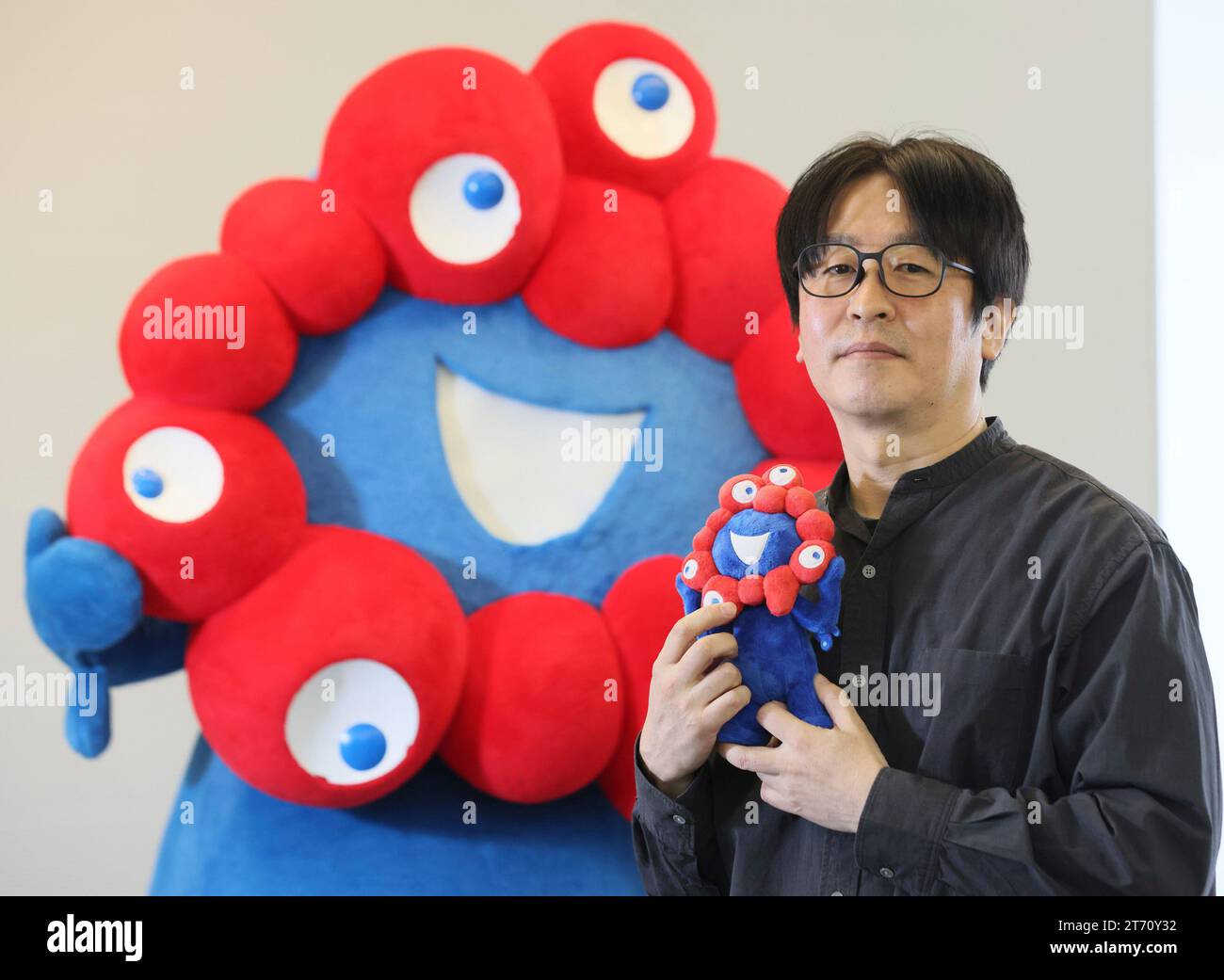 Japanese designer Kohei Yamashita holding a doll of "MYAKU-MYAKU", symbol of Expo 2025 Osaka ...