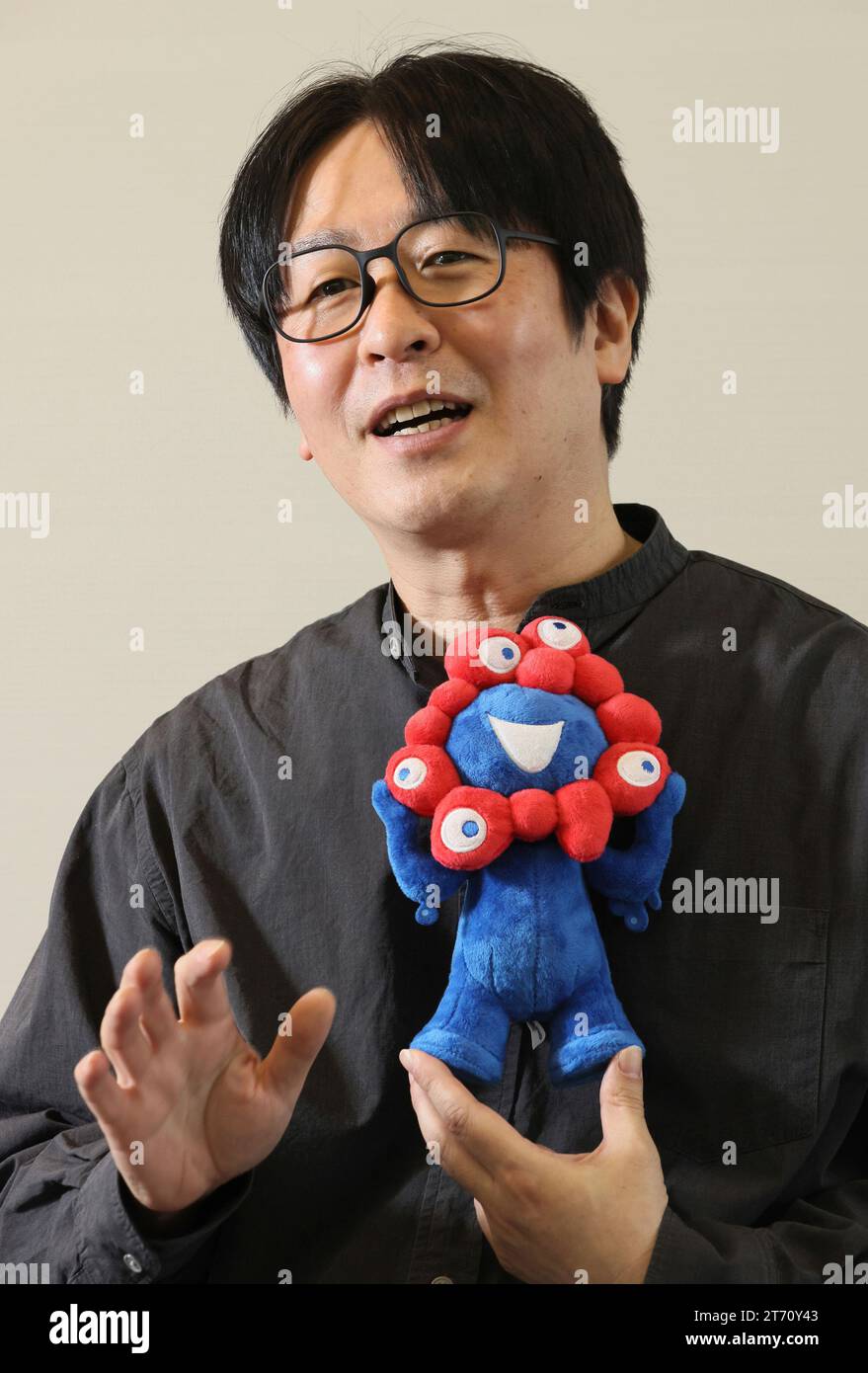 Japanese designer Kohei Yamashita holding a doll of "MYAKU-MYAKU", symbol of Expo 2025 Osaka ...