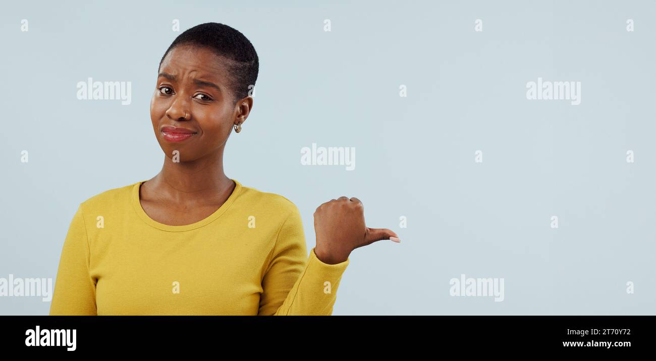 Disappointed, pointing and portrait of black woman in studio with why ...