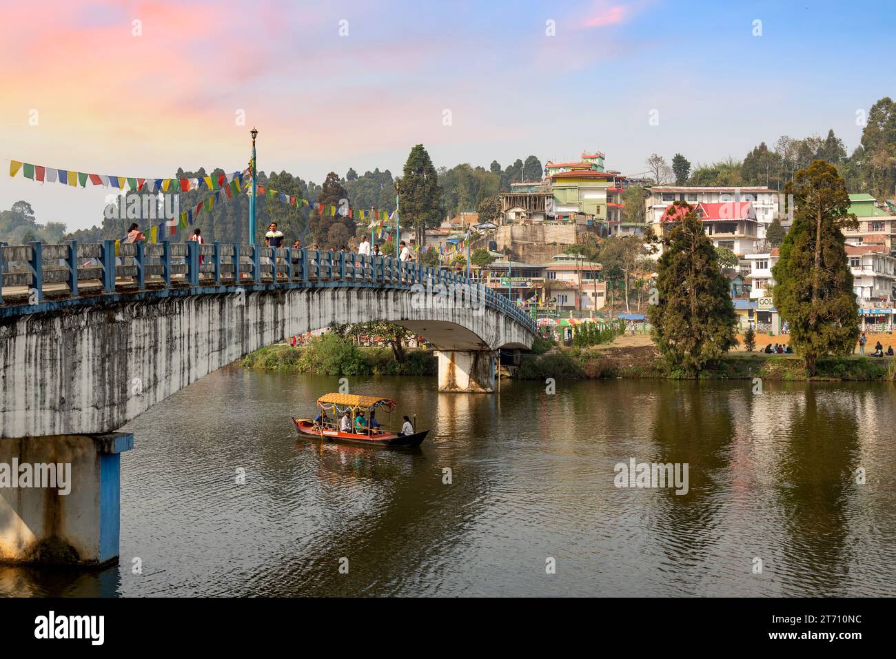 Mirik Lake with its cityscape and view of tourists boating at sunset ...