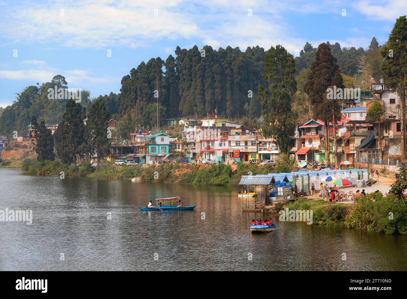 Mirik Lake with its cityscape and view of tourists boating at sunset ...
