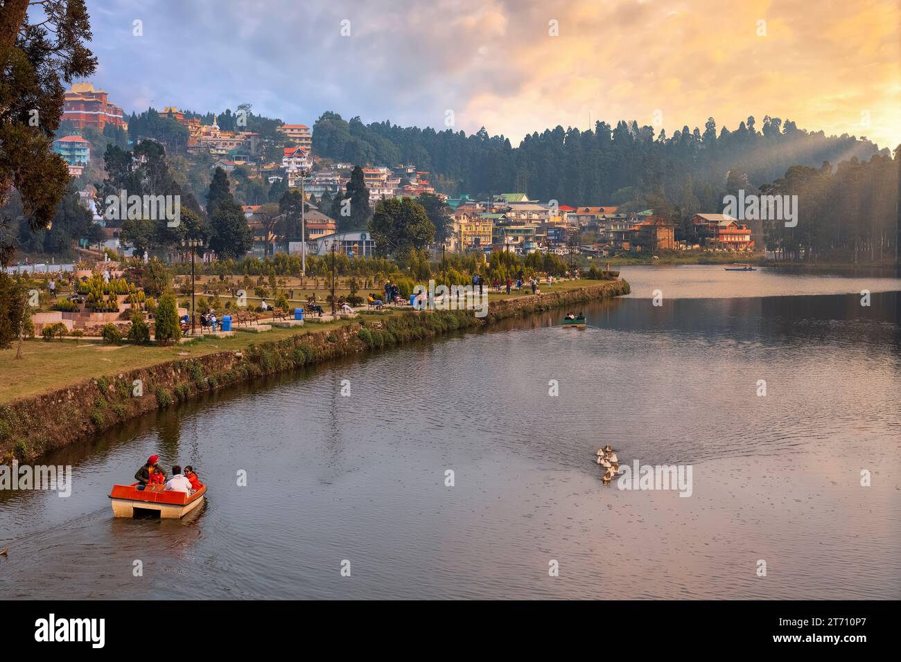 Mirik Lake with its cityscape and view of tourists boating at sunset ...