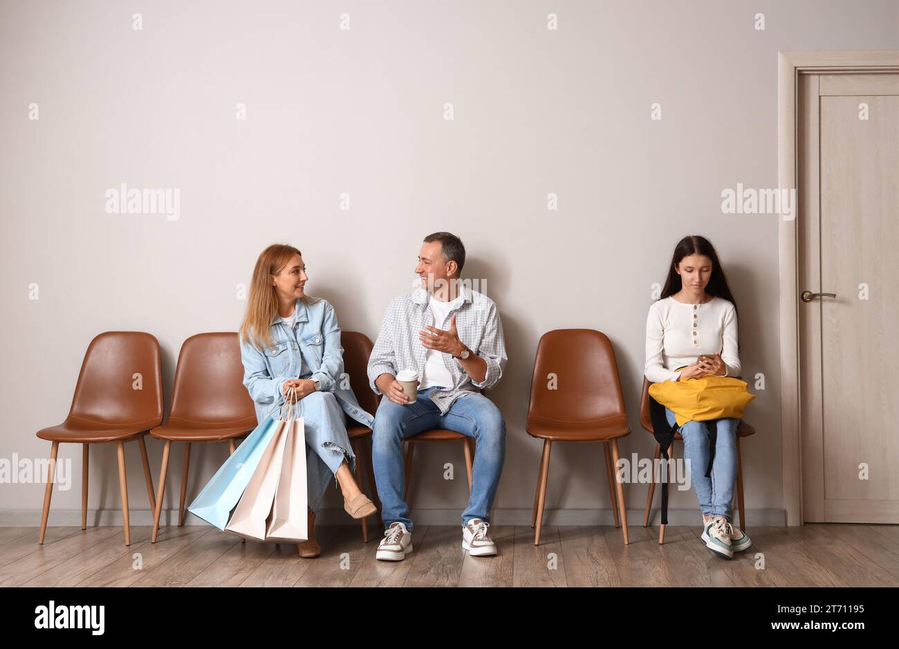 People waiting for their turn in room Stock Photo - Alamy