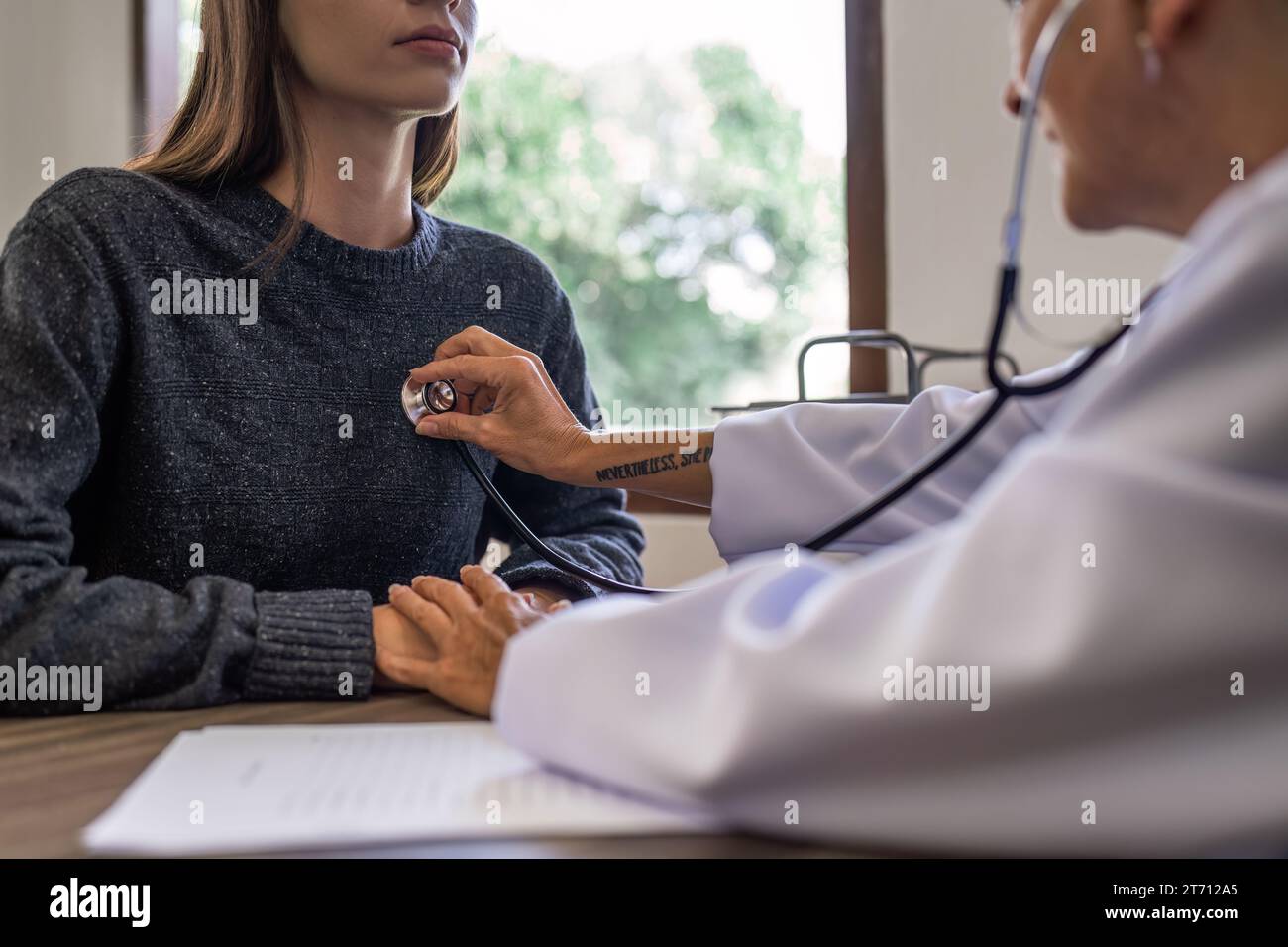 Doctor listens to heartbeat of patient middle age to check their heart ...