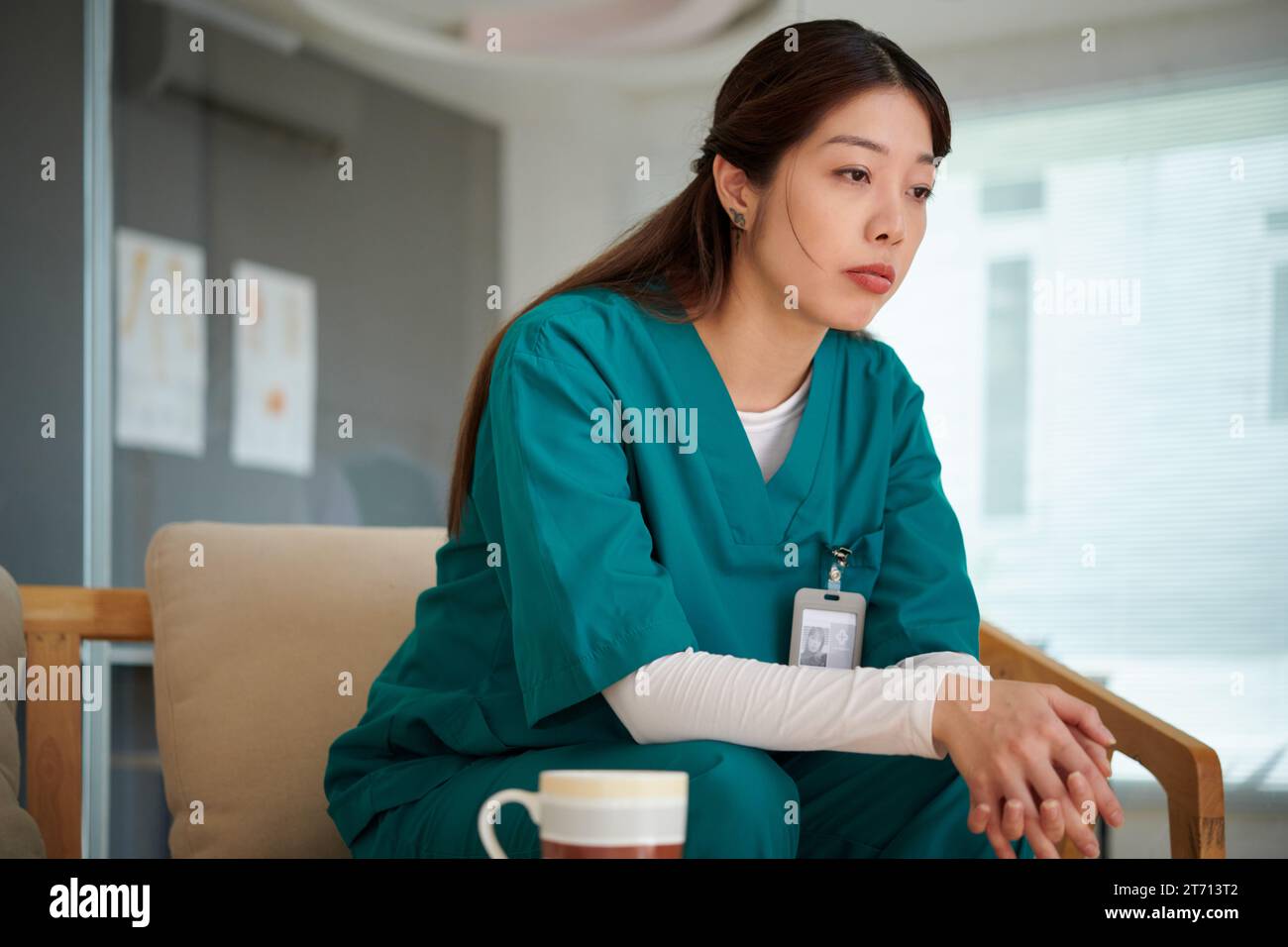 Stressed frustrated nurse thinking about patient she lost in surgery ...