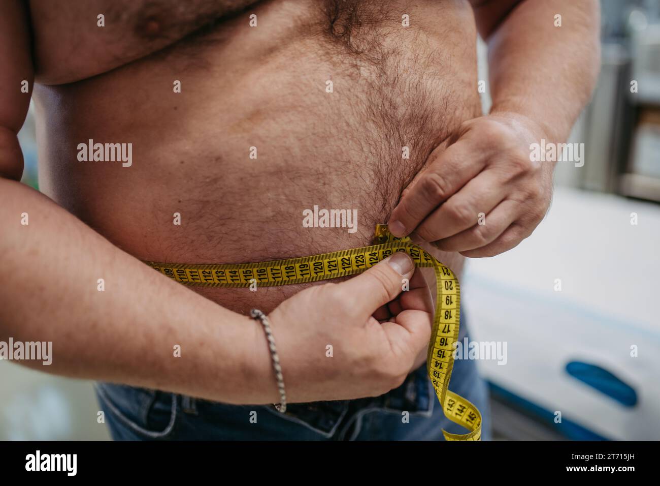 Close up of overweight man measuring waist, using tape measure. Obesity ...