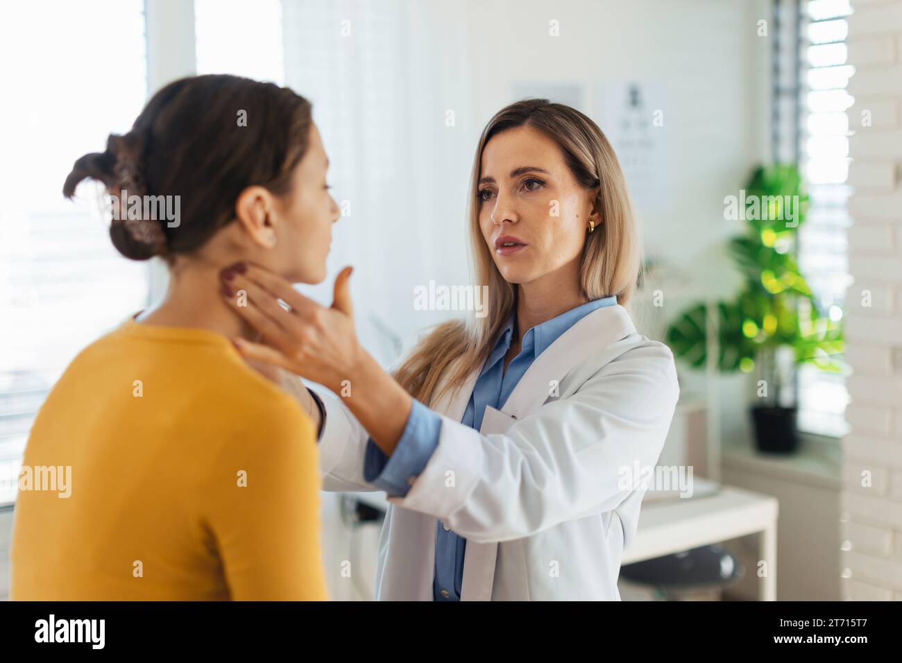 Doctor examining lymp nodes on neck of the teenage girl. Palpation of ...