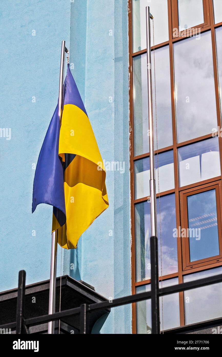 Ukrainian flag on a flagpole on an architectural building. Support and ...