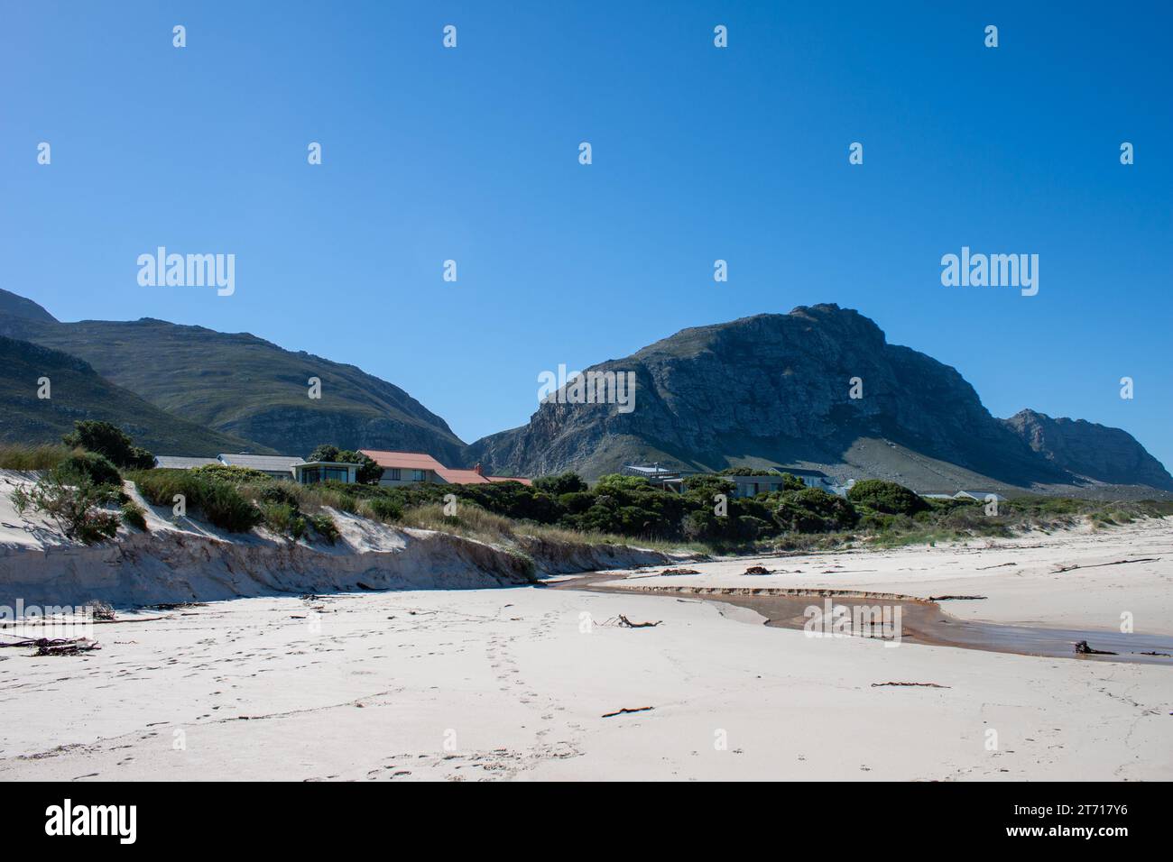A spectacular natural landscape with a towering cliff face overlooking ...