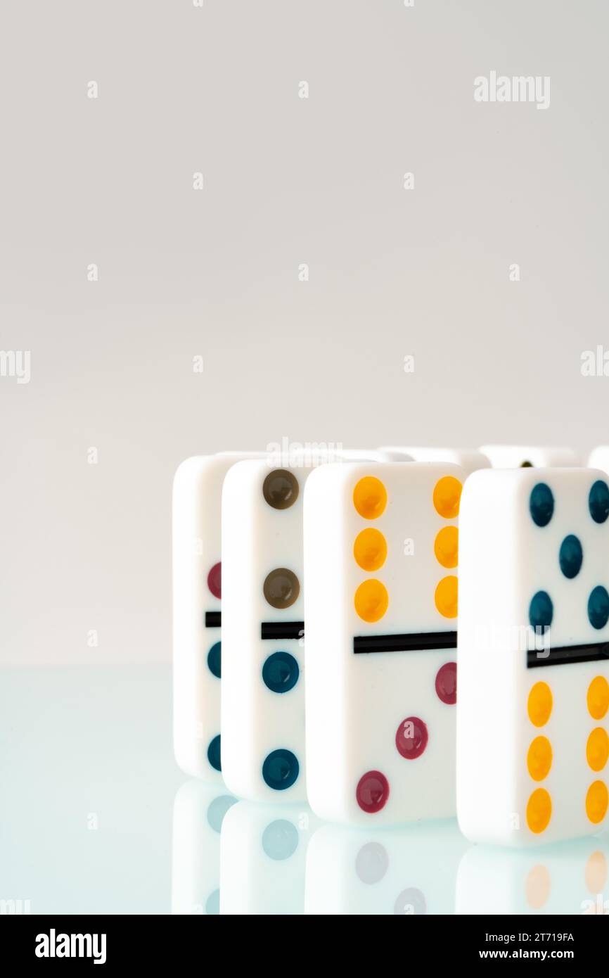 Domino tiles in a row on white background Stock Photo - Alamy