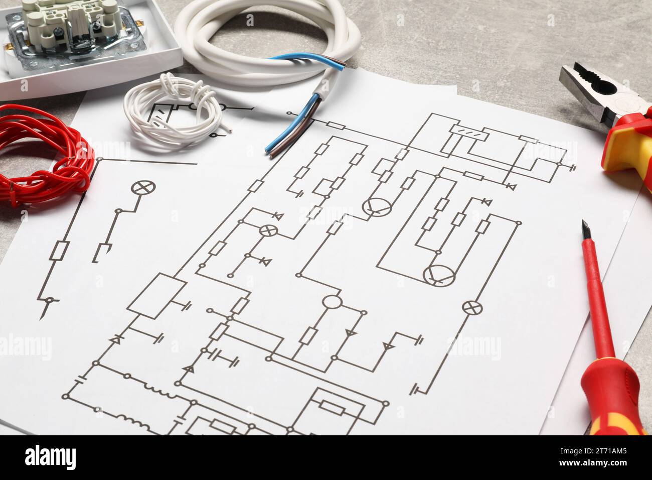 Wiring diagrams, wires and tools on grey table, closeup Stock Photo - Alamy