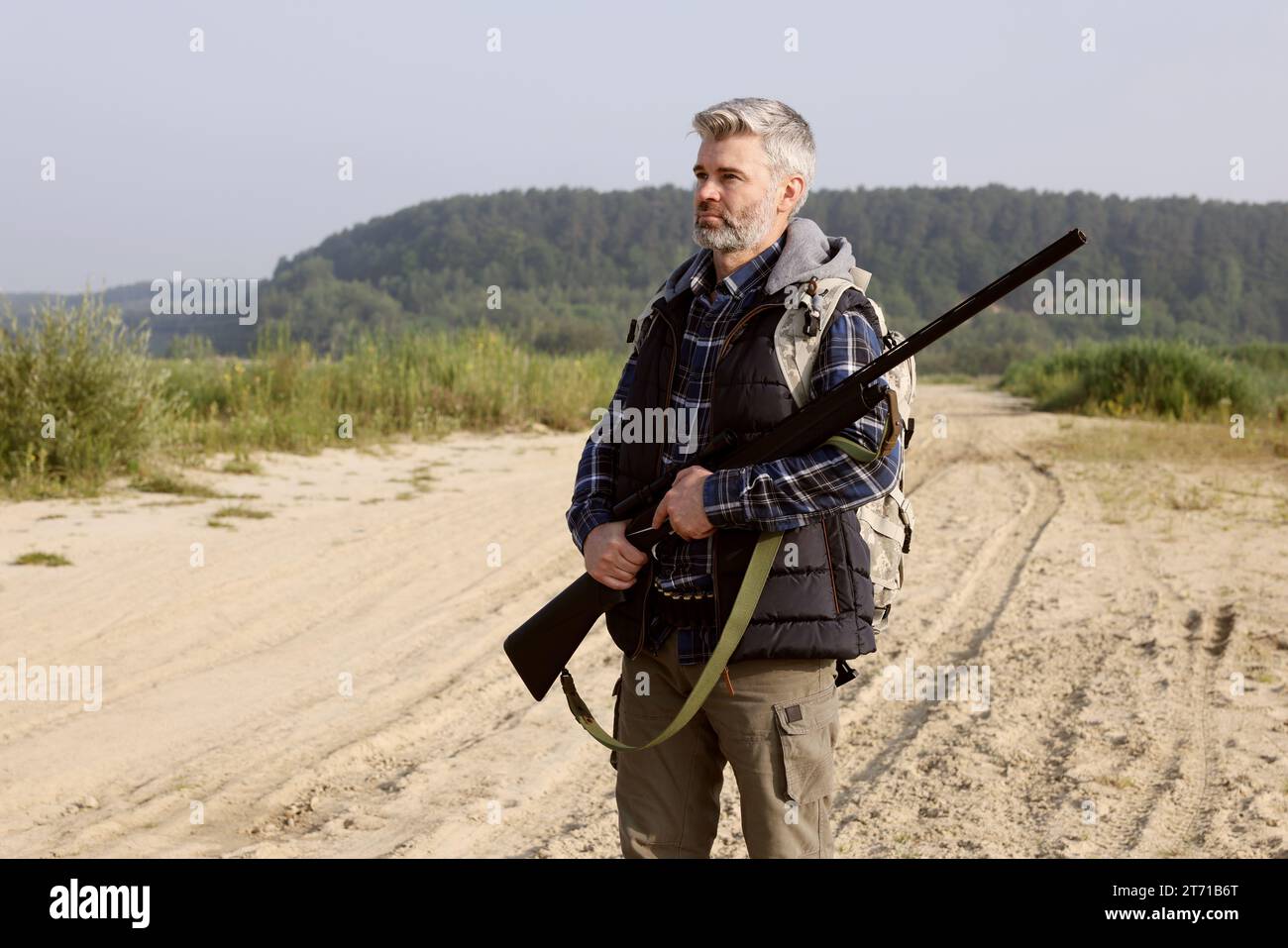Man with hunting rifle outdoors. Open season Stock Photo - Alamy